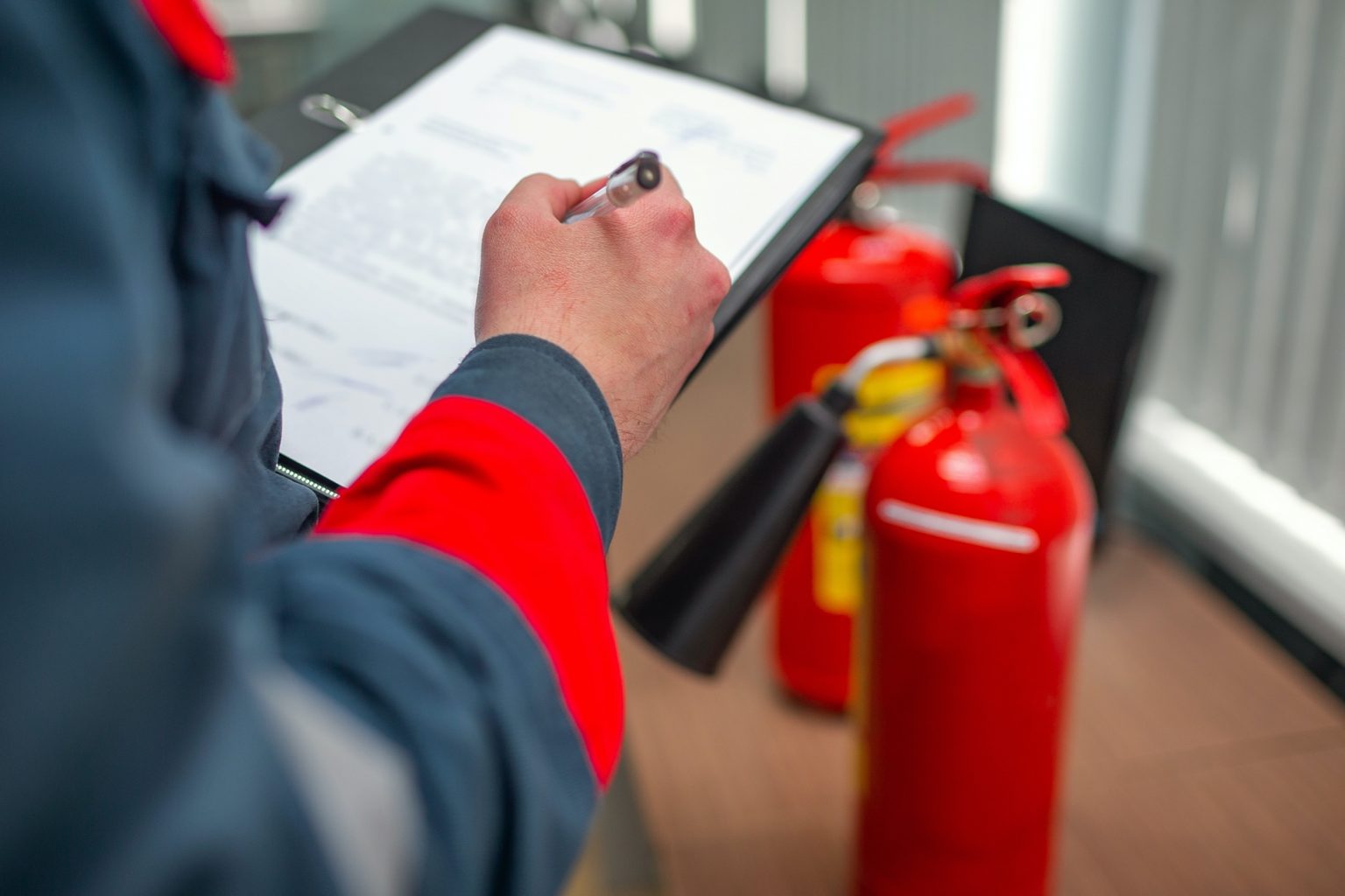 Engineer Professional are Checking A Fire Extinguisher Using Clipboard ...